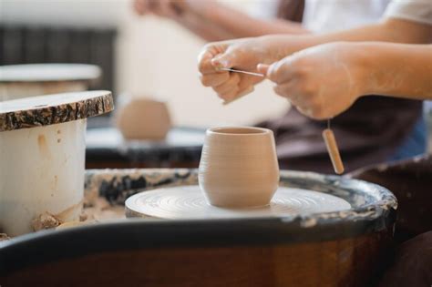 Premium Photo Hands Of A Potter Creating An Earthen Jar On The Circle
