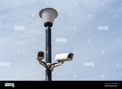 Surveillance Cameras Mounted On A Lamp Post Against A Blue Sky Security Cctv Camera Security