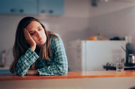 Tired Woman Feeling Sleepy Wearing Pajamas In Her Kitchen Stock Image
