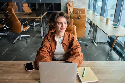 Free Photo Portrait Of Woman Working In Office Sitting At Table With Laptop Girl Programmer