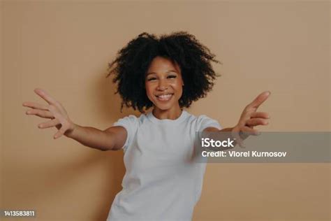 너무 기뻐행복한 아프리카 여자는 베이지 색 배경에 고립 된 서있는 동안 사람을 껴안고 싶어 25 29세에 대한 스톡 사진 및 기타 이미지 25 29세 감정 개념