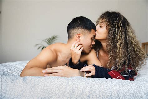 Lovers Cuddle On The Bed By Stocksy Contributor Michela Ravasio Stocksy