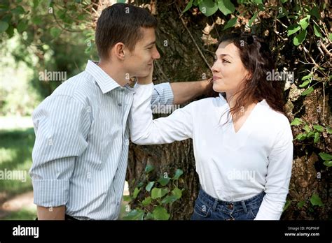Young Couple Walking In The Forest Posing Near Tree Summer Nature