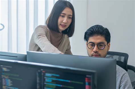 Asian And Indian Developer Team Discussion Feedback Analysis Coding Data With Software Computer