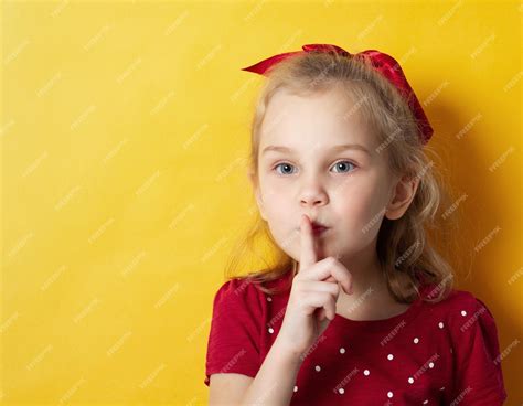 Premium Photo Portrait Of A Pretty Young Blonde Girl Showing Silence
