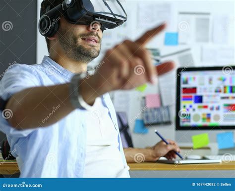 Young Male Software Programmer Testing A New App With 3d Virtual Reality Glasses In Office
