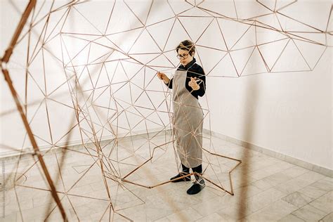 Female Sculptor Assembling A Complex Metal Sculpture In The Art