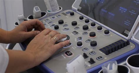 The Doctor Keeps His Hands On The Keyboard Of The Ultrasound Machine The Doctor Conducts The