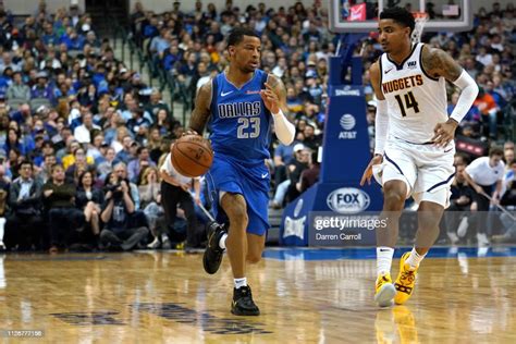 Trey Burke Of The Dallas Mavericks Handles The Ball Against The News