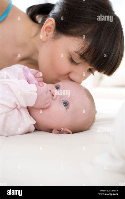 Mother Kissing Her Baby Stock Photo Alamy