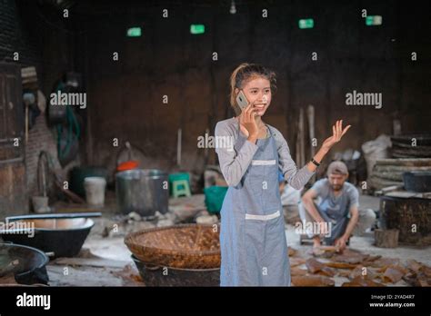 Portrait Of A Young Woman Engaged In Traditional Food Processing