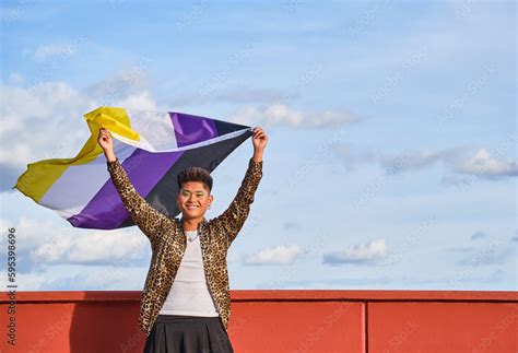 Gender Non Binary Asian Person Smiling Holding Gender Non Binary Flag
