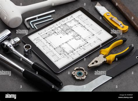Tablet With Construction Tools And Blueprint Concept Stock Photo Alamy