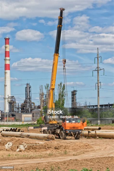 Construction Work On Pipe Laying Of Pipeline Into Trench Using A Crane