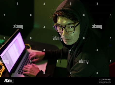 Asian Male Hacker Using A Laptop In Computer Server Room Stock Photo Alamy