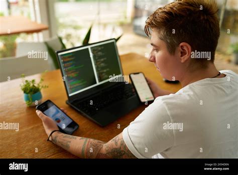 Person At Wooden Desk Engages In Intense Multitasking With Two