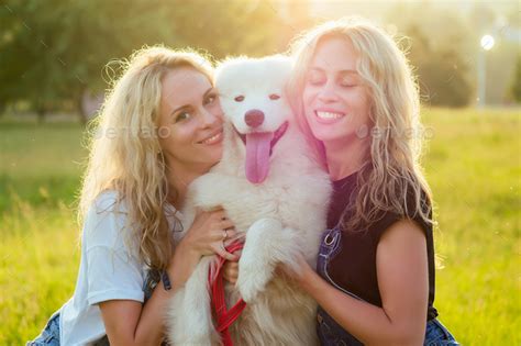 Two Beautiful And Charming Curly Blonde Twins Smiling Toothy Woman Stock Photo By Yurakrasil