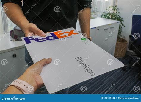 Business Woman Receive Envelope From Fedex Express Courier By Hand