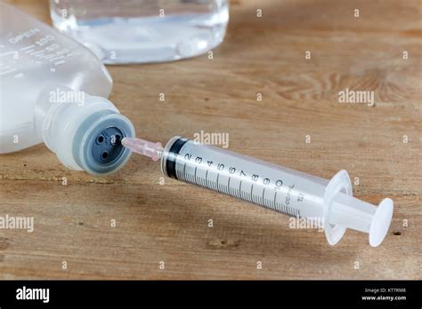 Saline Solution And Injection Needle Stock Photo Alamy