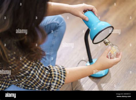 Asian Woman Changing Light Bulb In Lamp Renovation Using Equipment To Diy Repairing Light Bulb