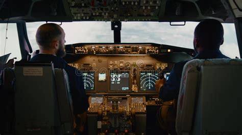 Diverse Captain And Copilot Switching Power Buttons To Fly Airplane Stock Footage Video Of