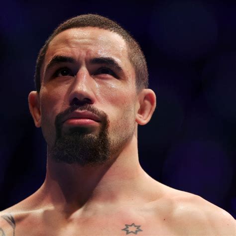 Download Ufc Fighter Robert Whittaker Posing Against A Black Backdrop