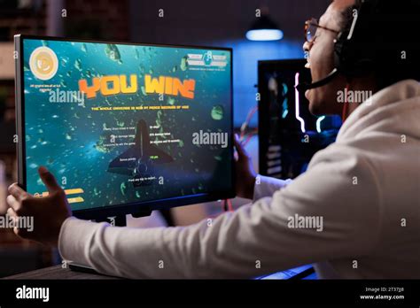 Ecstatic Gamer Playing Intense Classic Arcade Spaceship Racing Videogame Shaking Computer