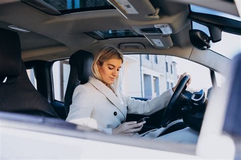 Free Photo Woman Sitting Inside Electro Car While Charging