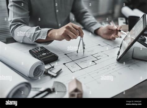 Architect Using Divider Compass Working On Blueprint House Planning Design And Construction