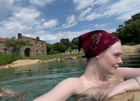 Elle Fanning Poses Topless In Cheeky Bikini Bottoms During Vacation