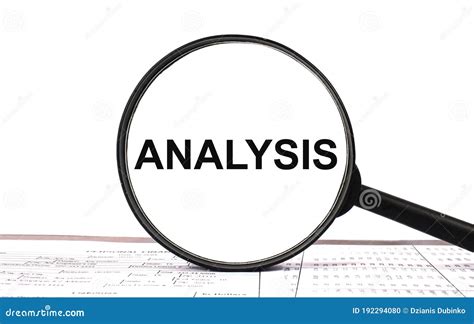 Magnifying Glass With Text Analysis On Financial Tables Stock Photo