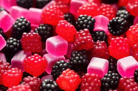 Colorful Assortment Of Raspberry And Blackberry Candy With Vibrant Gummy Squares On Display