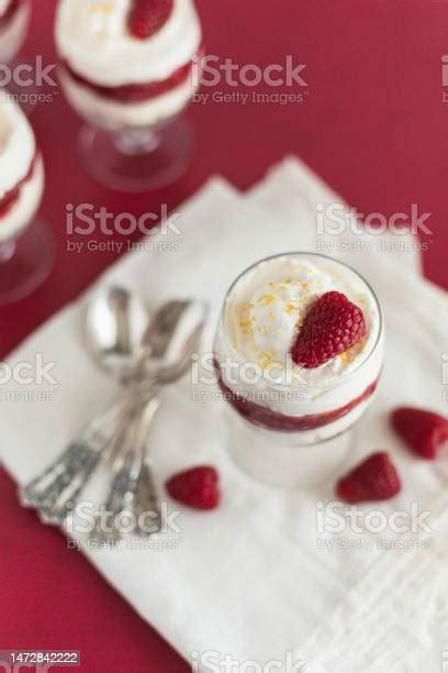 Raspberry Cheescake Parfaits On Red Surface And White Background Stock