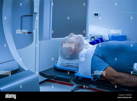 Patient In Mask For Whole Brain Radiotherapy Treatment Or Total Brain Radiotherapy To Target