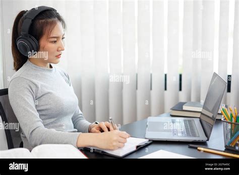 Office Work Concept A Female Secretary Writing And Taking Notes For What She Listening About
