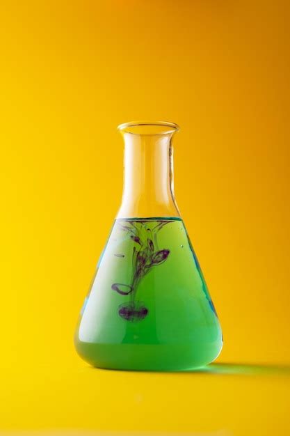 Premium Photo Close Up Of Flask Against Yellow Background